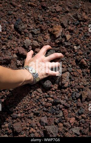 woman hand pick up volcanic stones Stock Photo - Alamy