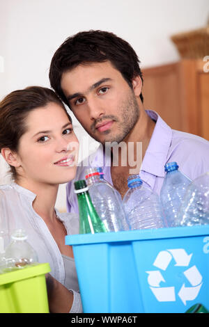 a young couple recycling plastic bottles Stock Photo - Alamy