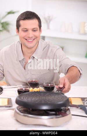 Man eating raclette Stock Photo - Alamy