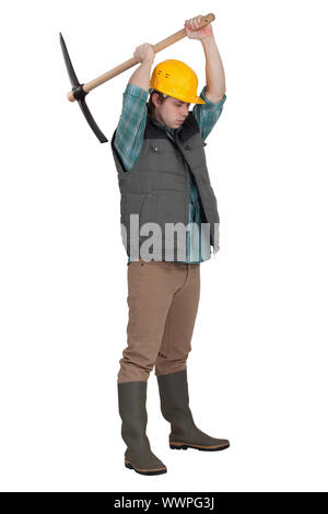 A man using a pickaxe Stock Photo - Alamy