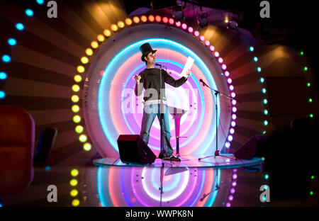 comedian with tile on stage of studio makes laugh of comedy show Stock ...