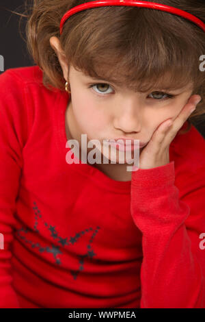 A little girl with a serious, pouting facial expression Stock Photo - Alamy