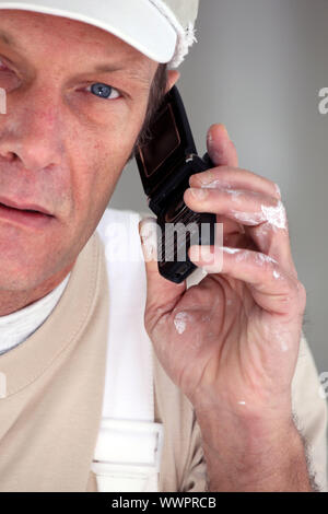 Painter making telephone call Stock Photo - Alamy