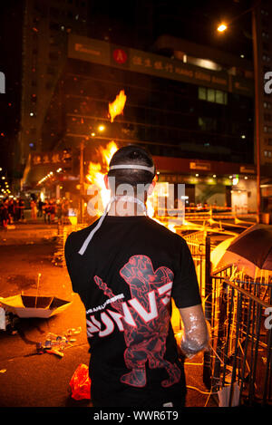 Police fire tear gas at anti-government protesters blocking a road in ...
