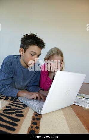 Smiling sibling doing homework together Stock Photo - Alamy