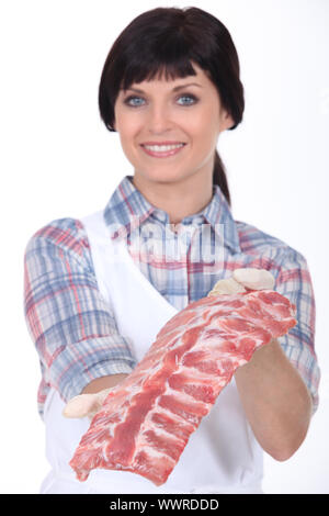 Female butcher holding a rack of ribs Stock Photo - Alamy