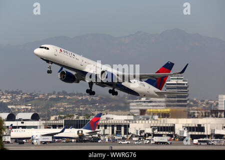 Delta Airlines Boeing 757 at LAX airport connected to jet bridge aerial ...