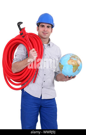 portrait of young plumber holding globe with hose over his shoulder ...