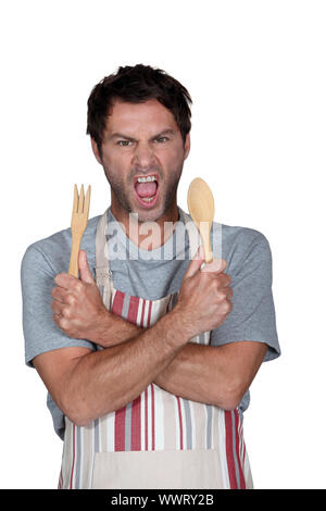Aggressive cook in apron Stock Photo - Alamy
