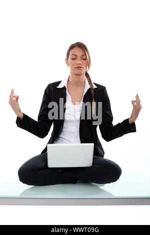 Businesswoman, sat in yoga position Stock Photo - Alamy