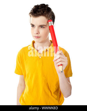 Thoughtful boy holding a pencil isolated on a white background Stock ...