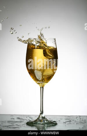 alcohol splash on gray background Stock Photo - Alamy