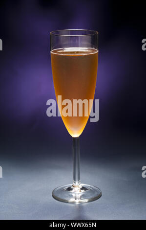 Champaign glass in front of blue purple background Stock Photo - Alamy