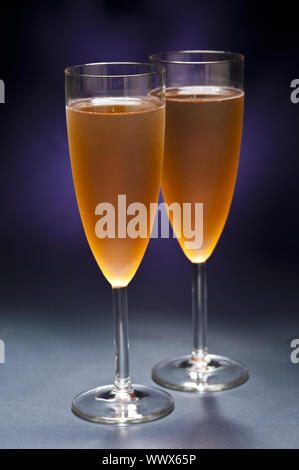 Champaign glass in front of blue purple background Stock Photo - Alamy