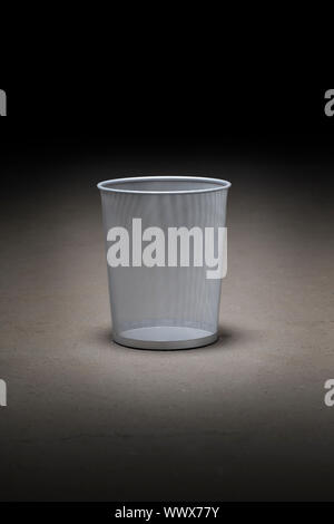 Empty wastepaper basket on dirty concrete floor Stock Photo - Alamy