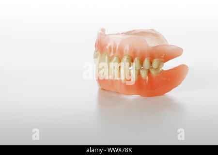 Old Stained Dentures on light grey background Stock Photo - Alamy