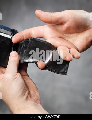 Man showing a hole in the coin pocket of his wallet Stock Photo - Alamy