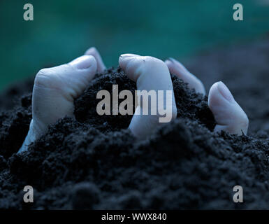 Hand emerging from the ground trough the soil Stock Photo - Alamy