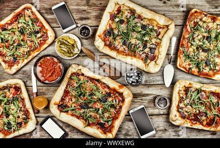 Friendly feast at home. Appetizing homemade pizza on a wooden table ...