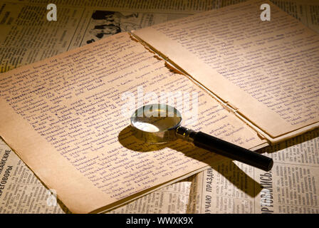 Magnifying glass over old newspaper Stock Photo - Alamy
