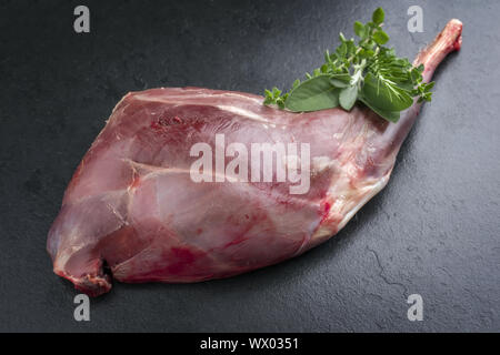 Raw Haunch of Venison as with herbs as close-up on a slate slab Stock ...