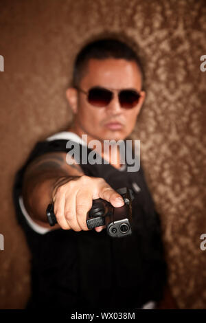 Hispanic Cop Pointing Gun at Camera Gangster Style Stock Photo - Alamy