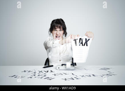 Desperate woman at her taxes-paperwork covered desk to crying bitter ...