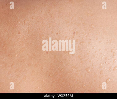 Woman with good skin and cream drops on face over white background in ...