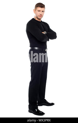 Handsome young bodyguard, full length portrait. Arms folded Stock Photo ...