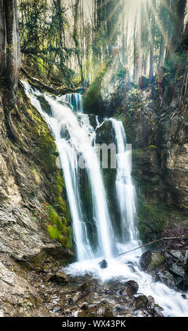 Waterfall water shining with sunlight in a remote and preserved place ...