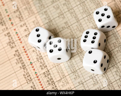 Dice and stock market charts in the newspaper Stock Photo - Alamy