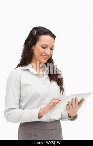 Brunette standing while using a touchpad against white background Stock ...