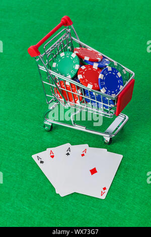 poker chips in shopping cart on white background Stock Photo - Alamy