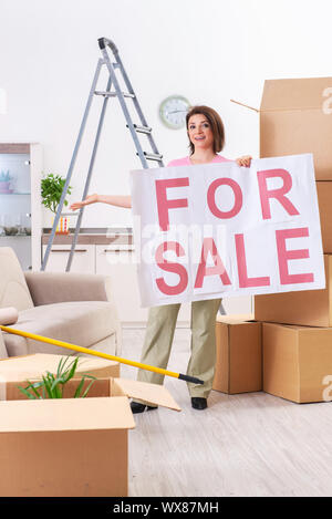 Middle-aged woman selling renovated flat Stock Photo - Alamy