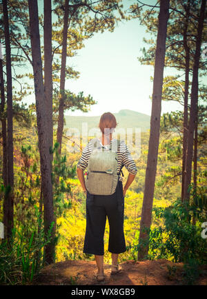 Tourist with backpack in highland Stock Photo - Alamy