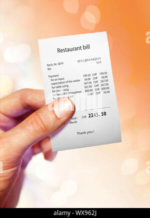 Restaurant bill for a large sum of money on hand Stock Photo - Alamy
