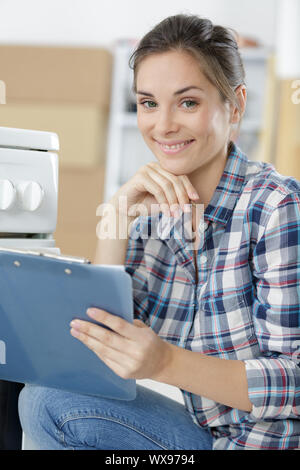 laundry worker taking notes about broken machine Stock Photo - Alamy