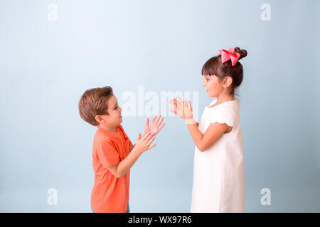 Kids playing hand clapping games Stock Photo - Alamy