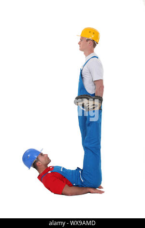 Two builders forming letter N Stock Photo - Alamy