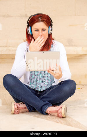 portrait of a cute charming girl listening to her favorite song with ...