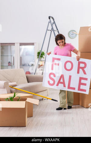 Middle-aged woman selling renovated flat Stock Photo - Alamy