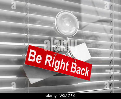 Sticky note with text BE RIGHT BACK, computer keyboard, chain and ...