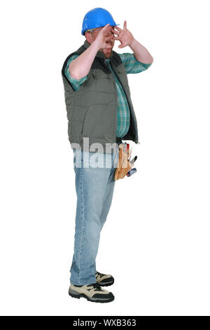 An ashamed blue collar worker is hiding his face Stock Photo - Alamy