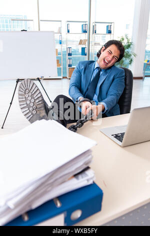 Chained employee unhappy with excessive work in the ofiice Stock Photo ...