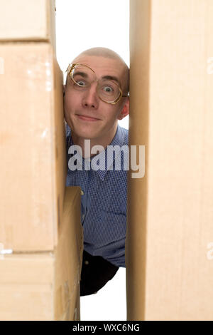 Male face clamping between cardboard boxes on white Stock Photo - Alamy