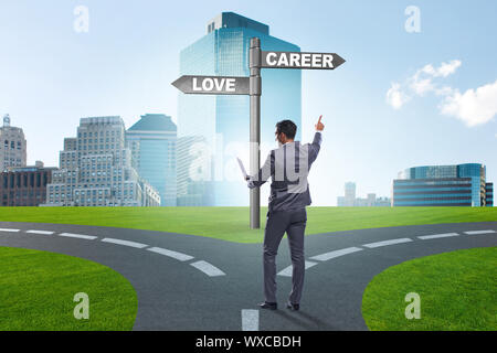 The businessman having hard choice between love and career Stock Photo ...