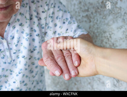 Closeup of young lady's hand holding a soft pink rubber covered mobile ...