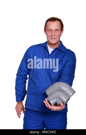 Male plumber with pipe on brown background Stock Photo - Alamy