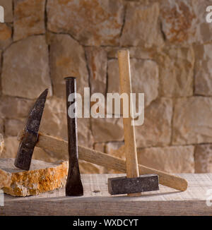 Hammer mason tools of stonecutter masonry work in a contruction stone ...