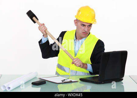 Laborer destroying computer with hammer Stock Photo - Alamy